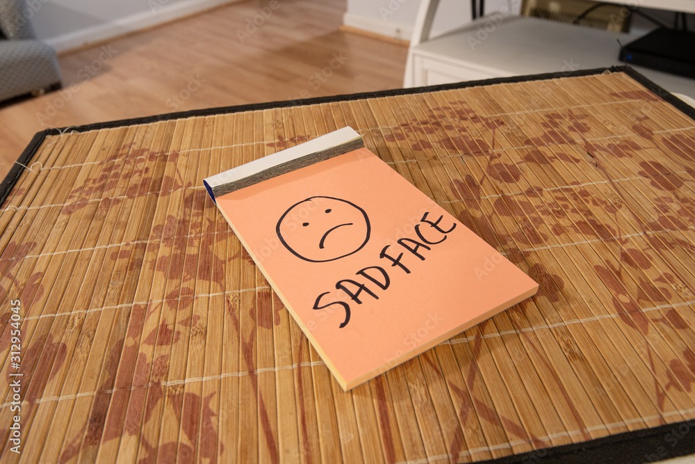 note on your pad says sad face with a frowny face drawing Stock Photo ...