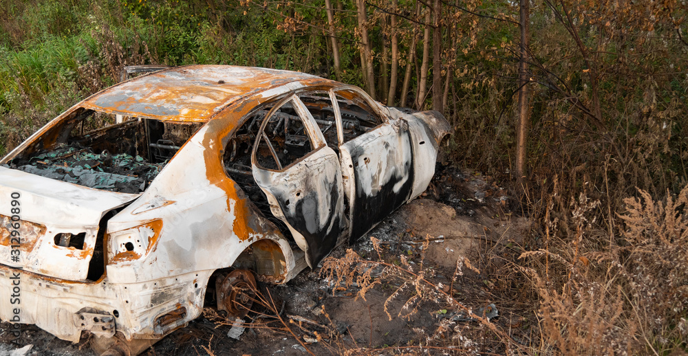 Burnt out, Wrecked car closeup, after an explosion or fire. view of a ...