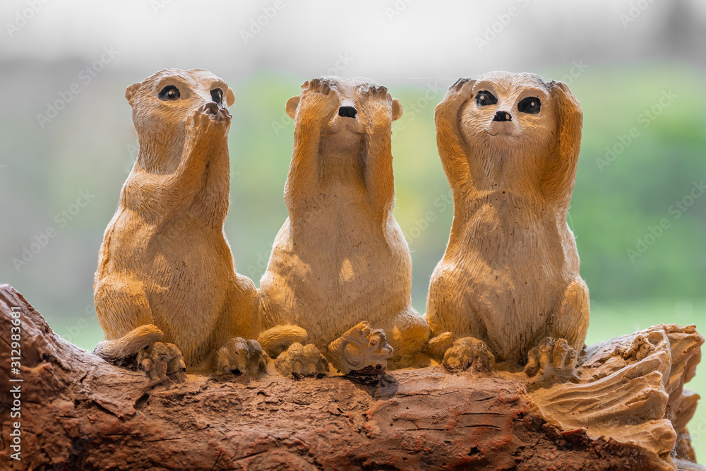 Three ceramic meerkats depicting the proverb.Speak no evil.See no evil ...