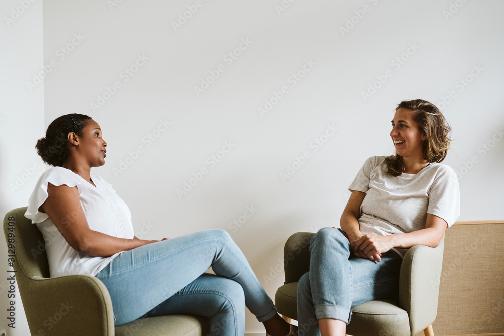 Smiling women talking together Stock Photo | Adobe Stock