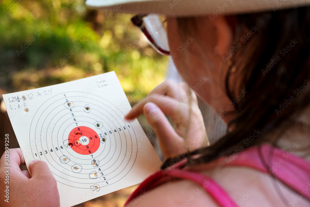 Girl checking shooting target Stock Photo | Adobe Stock