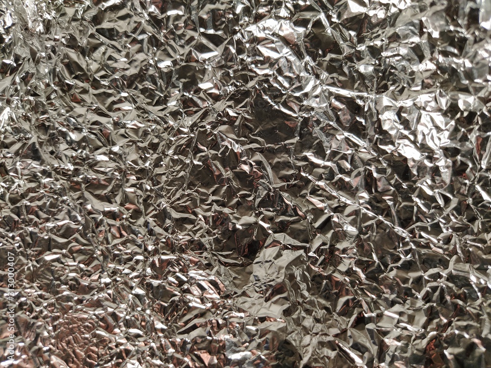Crumpled aluminum foil. Reflection and refraction of light in different ...