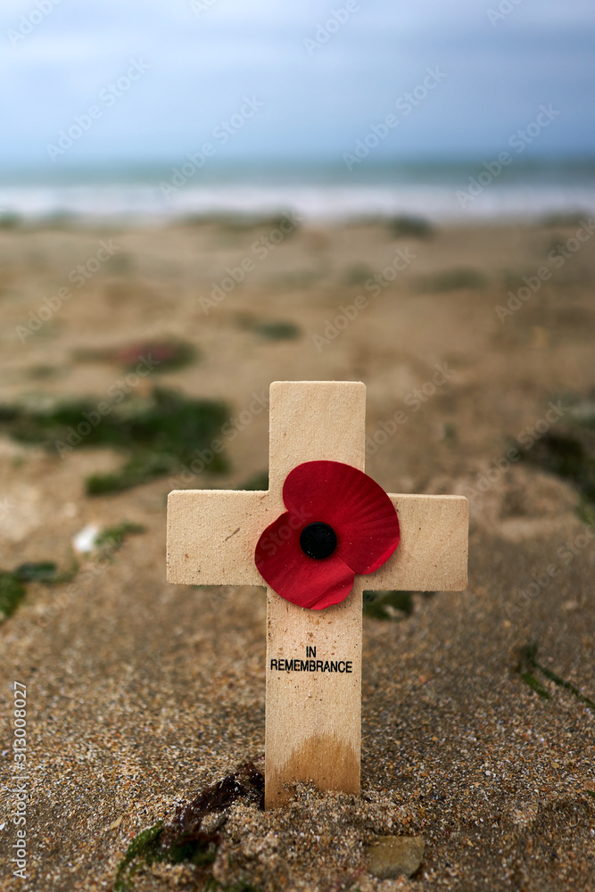 Wooden cross in the sand at Utah Beach in the Normandy to remember the ...