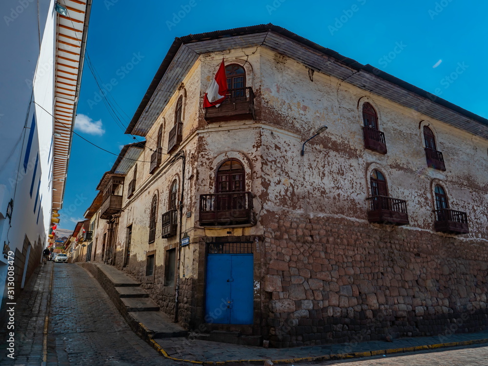Common corner of cobbled street in City of Cusco, Peru. Base of houses ...