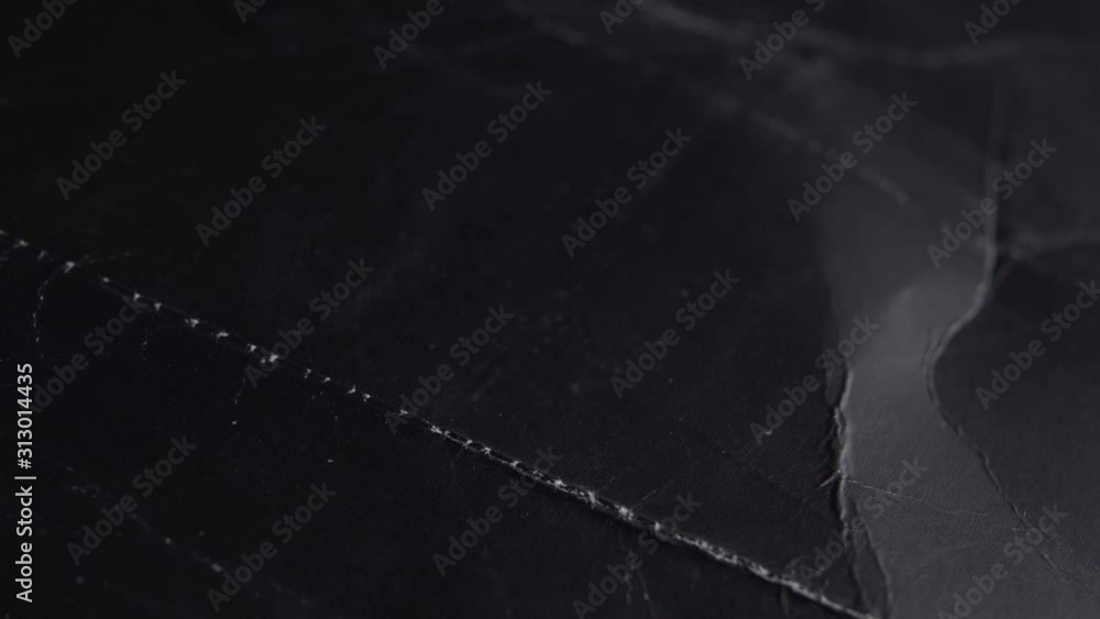 Vidéo Stock Old black wrinkled paper with scuffs and wrinkles. Slow ...