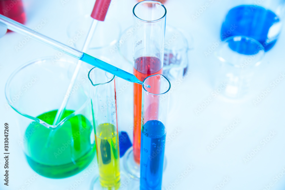 Several test tubes and solution beakers in a science laboratory with ...