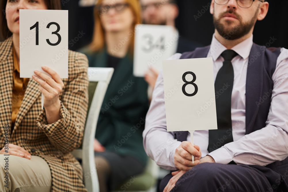 Group of business people holding signs with numbers while they sitting ...