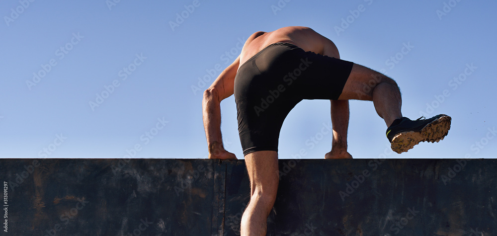 Mud race runners running over obstacles extreme sport Stock Photo ...