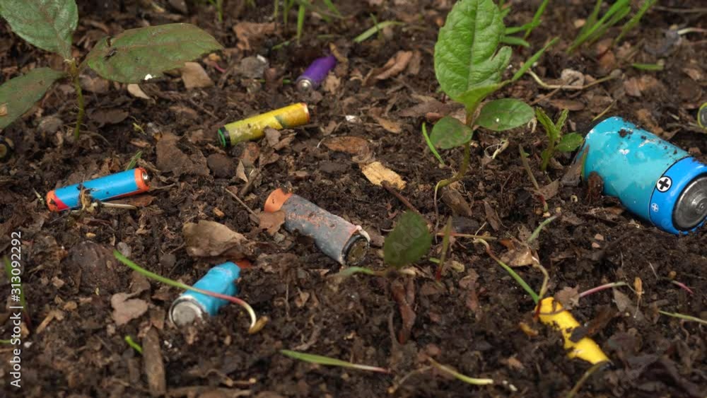 Used rusty batteries in soil. Electronic pollution is the form of ...