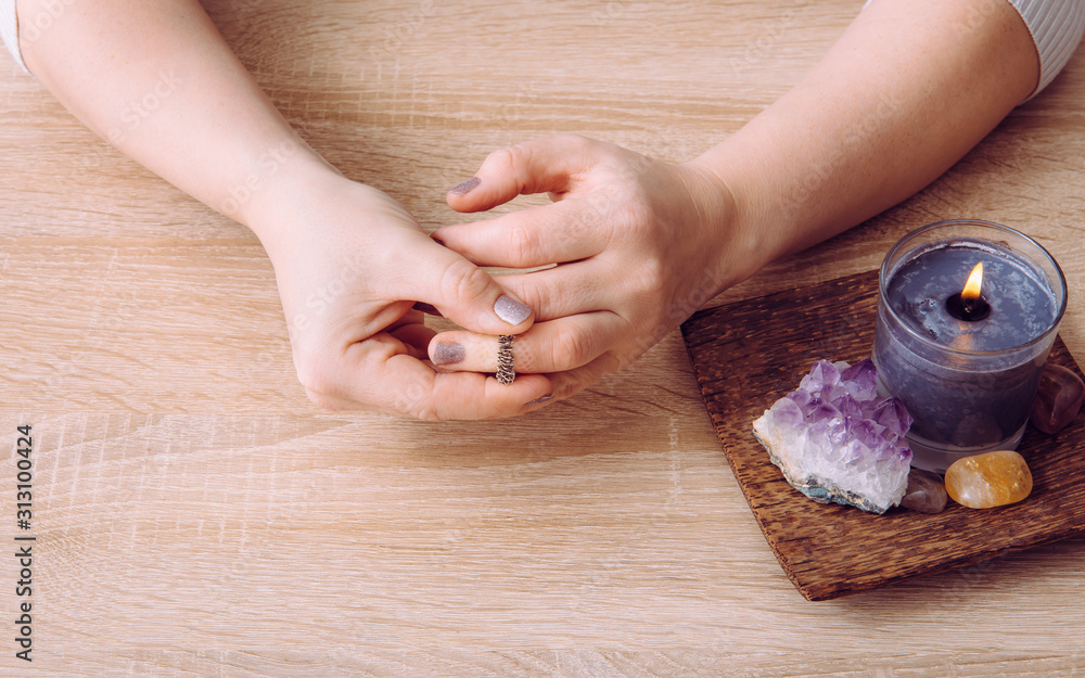 Woman using acupressure massage ring on fingers. Acupressure is an ...