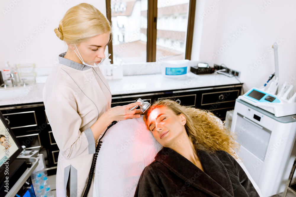 Female doctor conducts procedure for rejuvenating facial skin ...