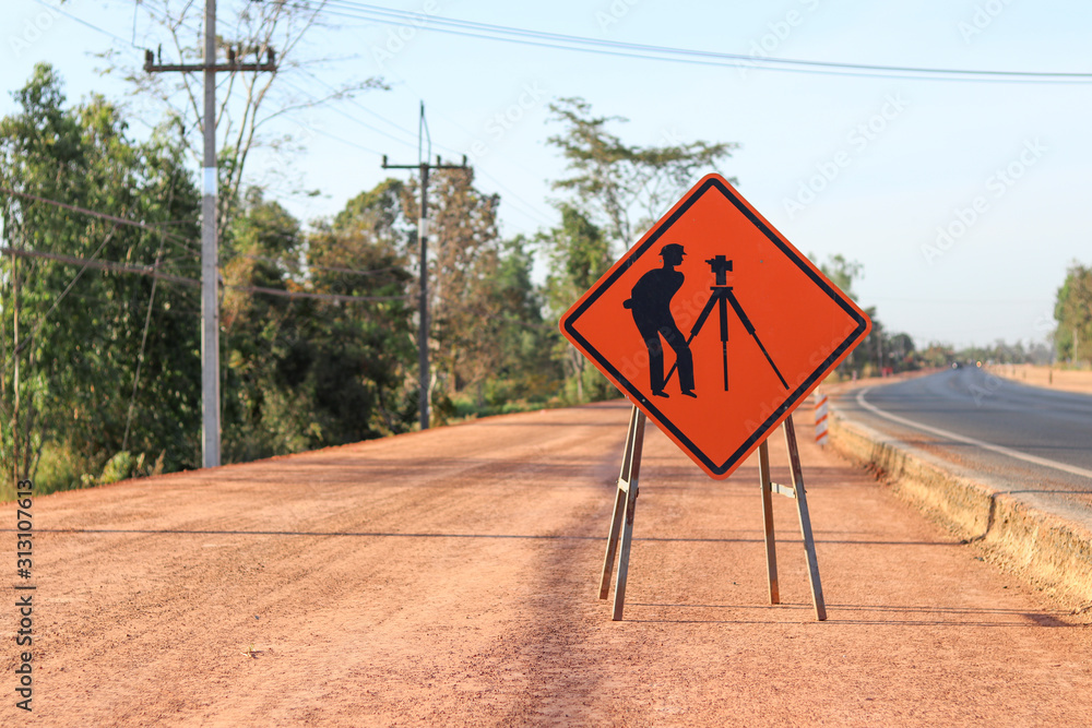 Orange label with pictograms survey engineering inside placed along the ...