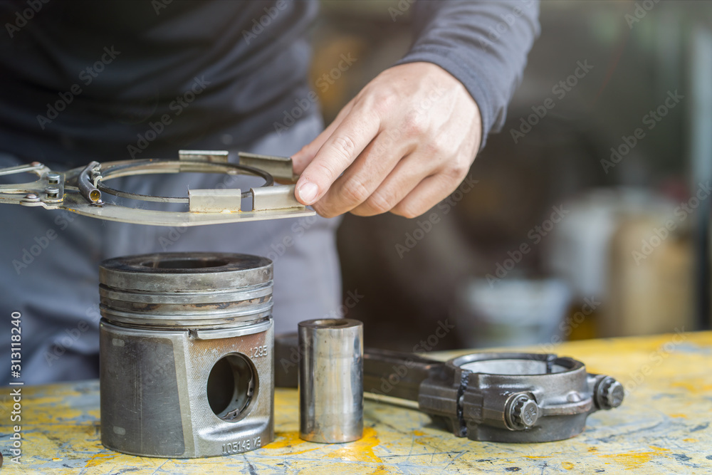mechanic man using clamping piston ring tool to remove and install ...