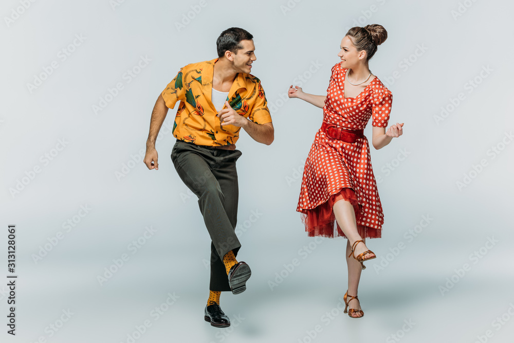 stylish dancers looking at each other while dancing boogie-woogie on ...