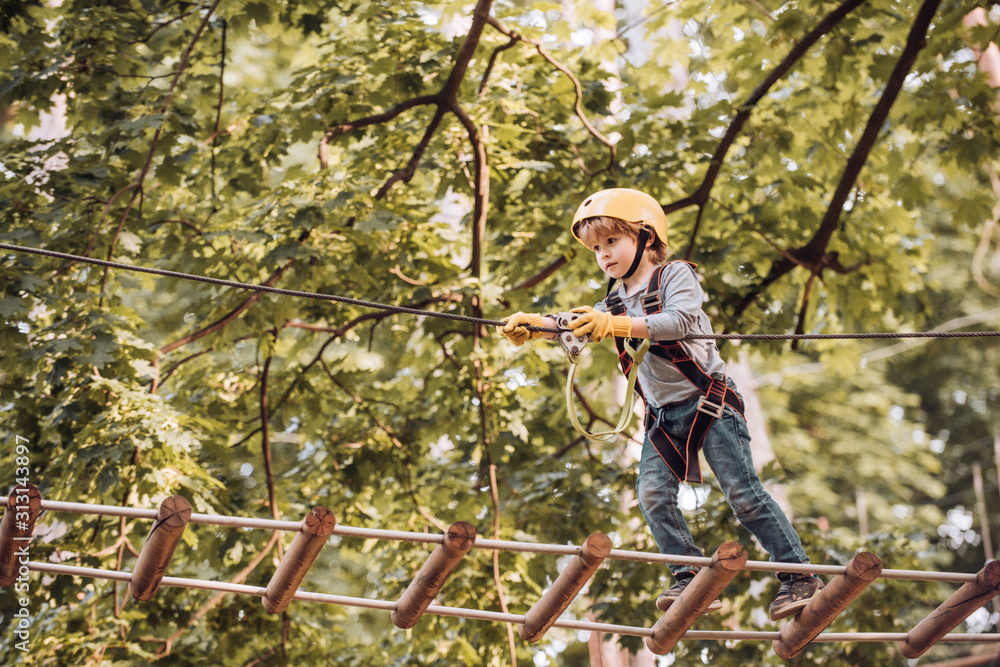 Balance beam and rope bridges. Go Ape Adventure. Child concept. Climber ...