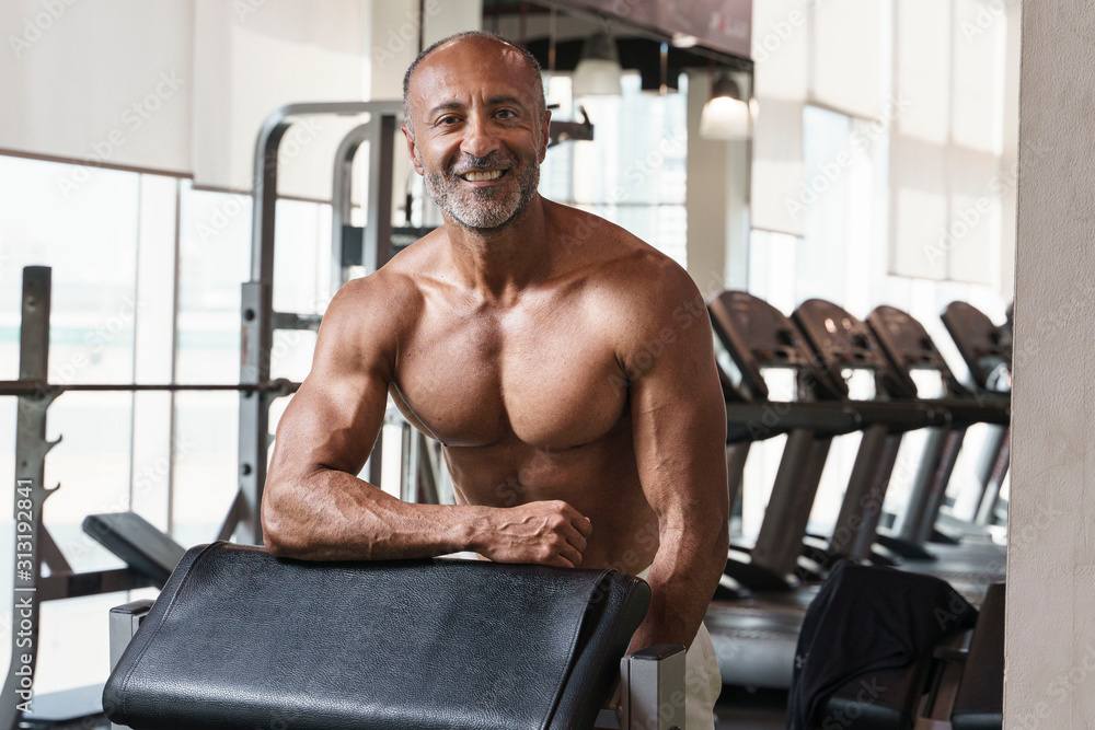 Muscular shirtless mature older bodybuilding athlete with balding gray ...