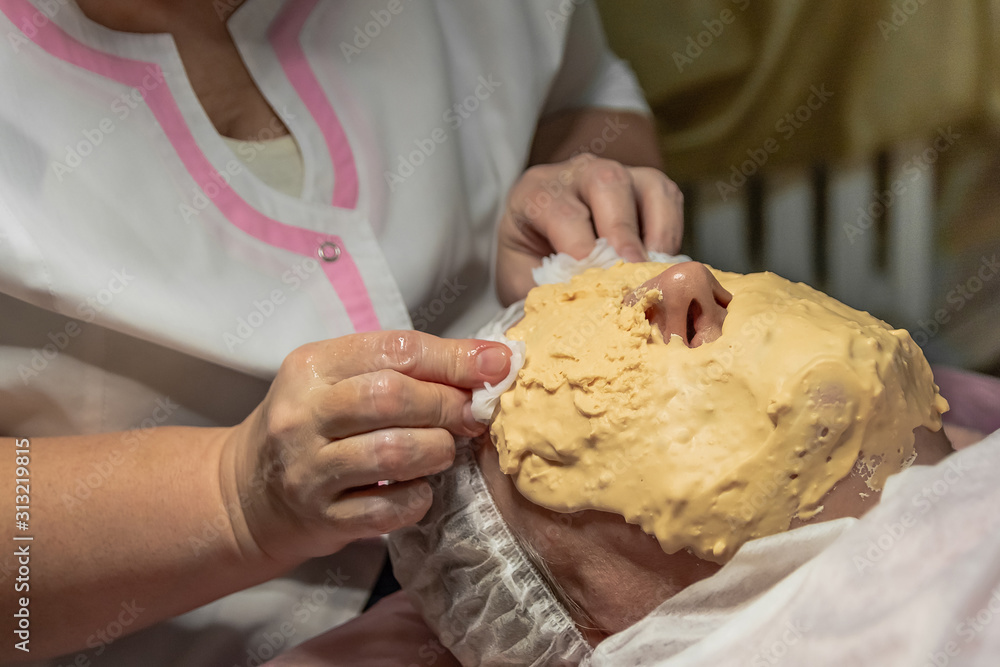 Cosmetic procedure with laying alginate masks on the face in a beauty ...