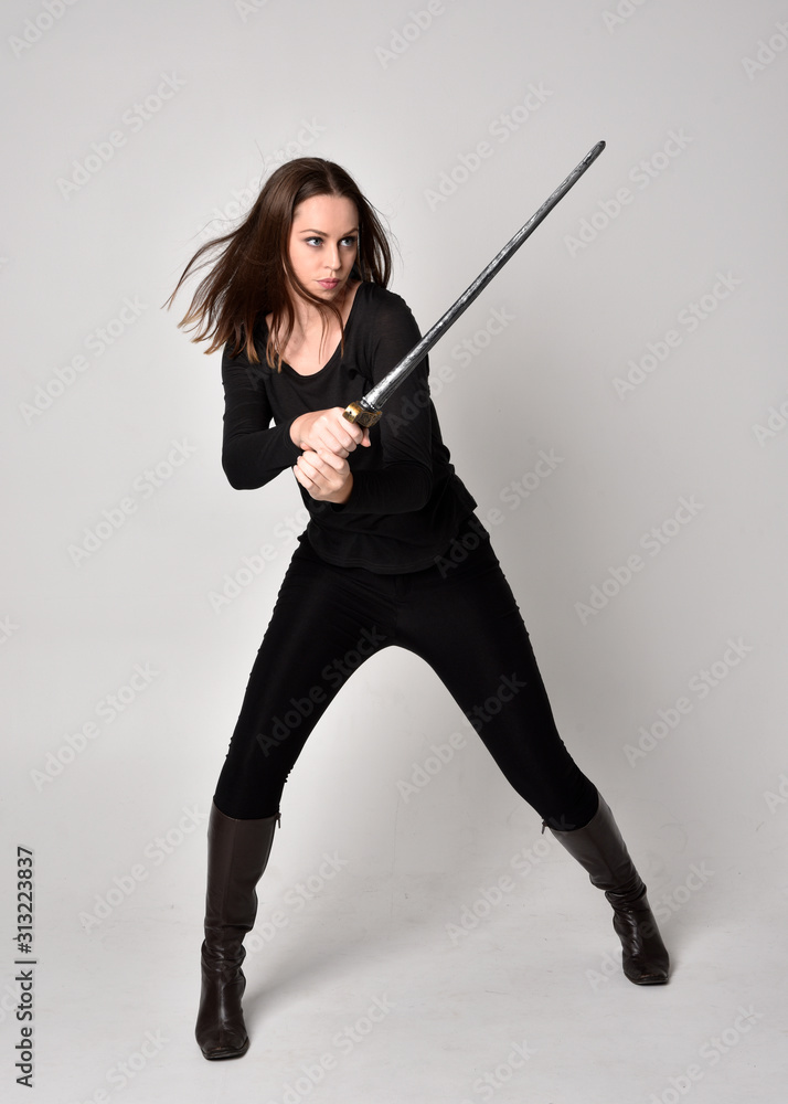 full length portrait of a pretty brunette girl wearing a black shirt ...