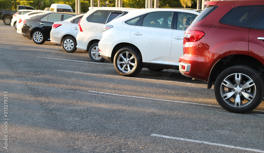 Closeup of rear, back side of red car with other cars parking in ...