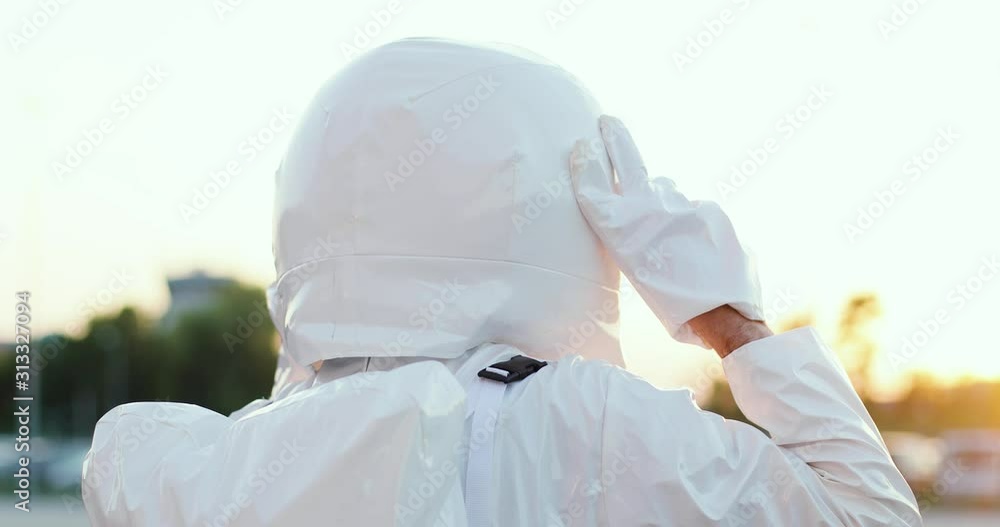 Close up of the rear of Caucasian young man astronaut taking on head ...