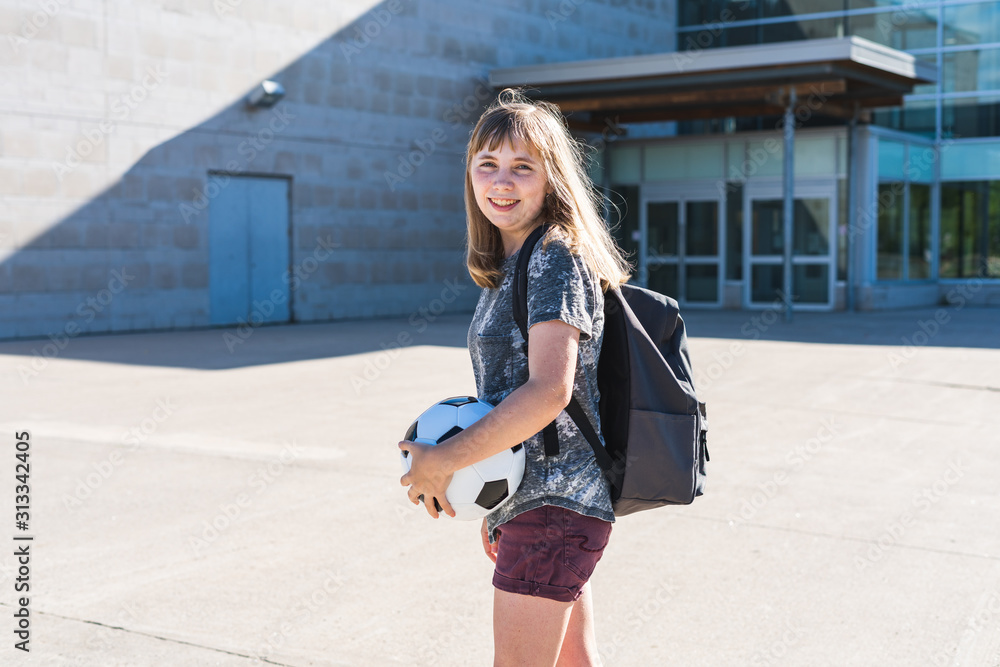 Happy/Excited Student standing in front of High School while wearing a ...