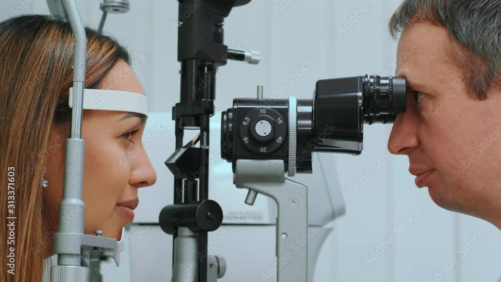 Eyes measured with refractometer at optician or ophthalmologist ...