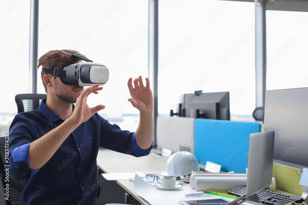 Shot of an engineer wearing a VR headset in an new building. Change the ...