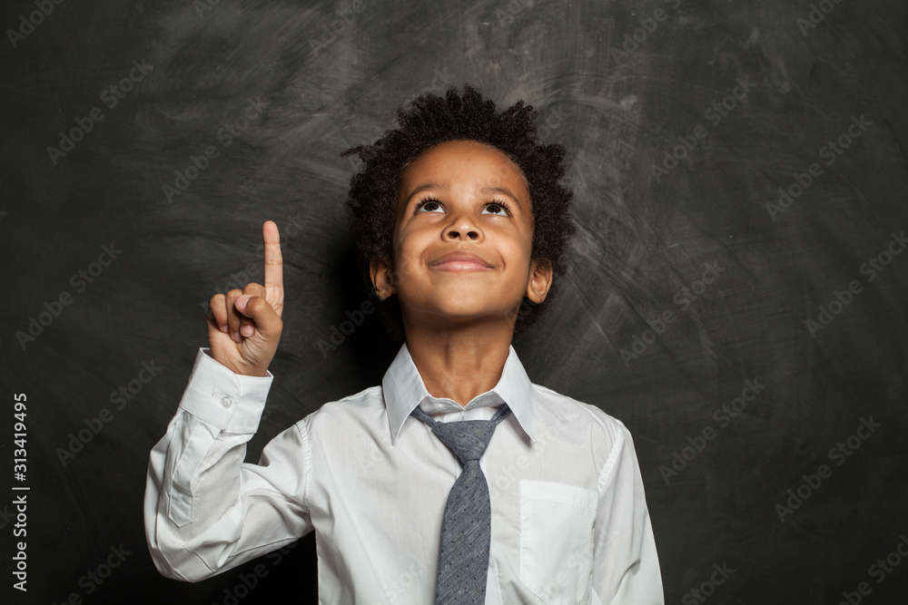 Kid little boy pointing up on black background Stock Photo | Adobe Stock