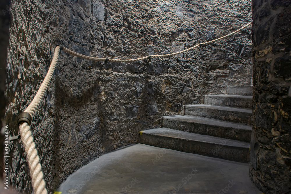 Spiral stone staircase with rope handrail in an old castle Stock Photo ...