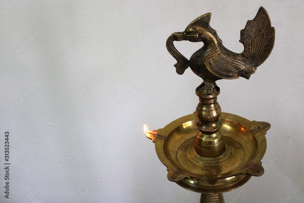 Traditional oil lamp on light background.Nilavilakku Stock Photo ...