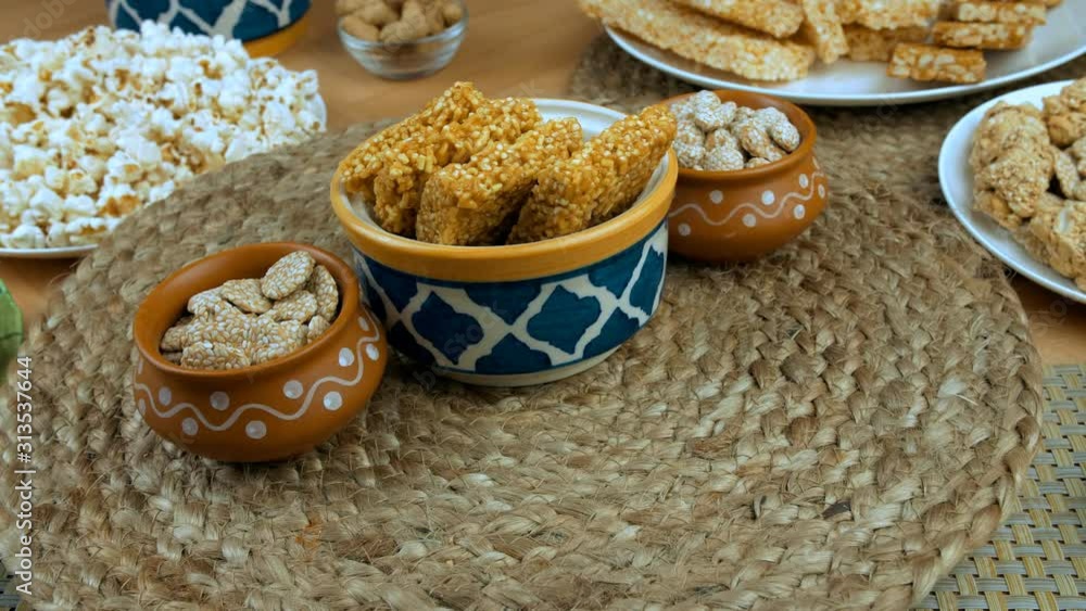 Pan shot of beautifully plated Lohri items consumed during the winter ...