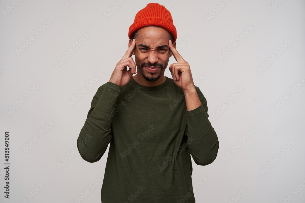 Displeased young attractive dark haired dark skinned man with beard ...