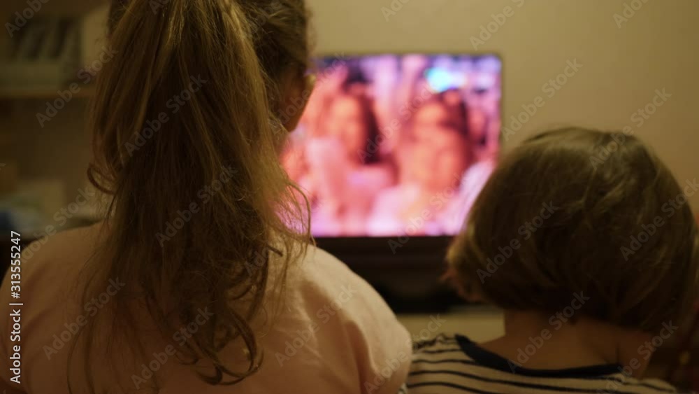 Vidéo Stock Little Kids While Watching TV. Children Watch Television on ...