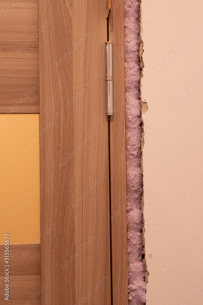 Installation of doors using polyurethane foam mounting Stock Photo ...