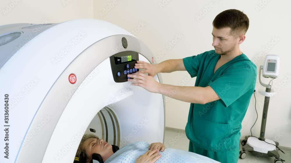 Professional radiologist controls CT or MRI or PET scan with elderly ...