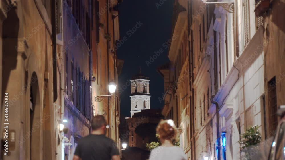 Night city life on ancient Roman street in the city centre. Illuminated ...