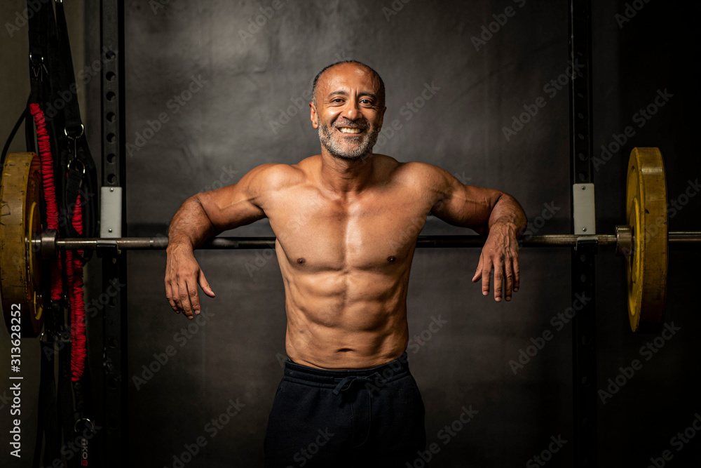 Muscular shirtless mature older bodybuilding athlete with balding gray ...