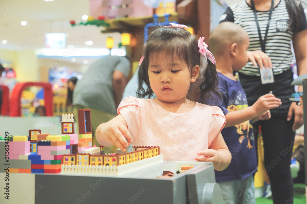 Little girl build a tower and funny with educational toy blocks. Stock ...