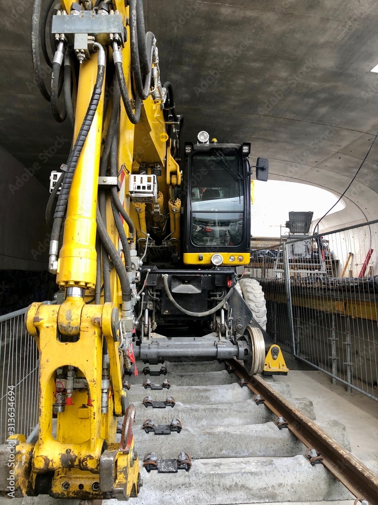 Laying rails: Special wheel excavator for work on the rails on the ...
