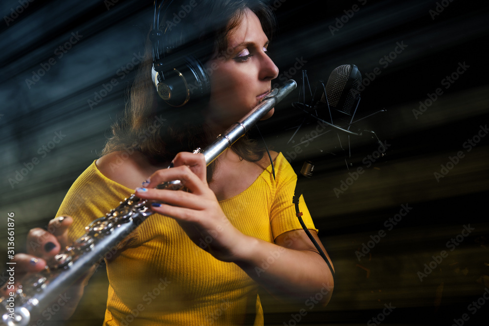 Professional recording of musical instruments at studio. Flautist in ...