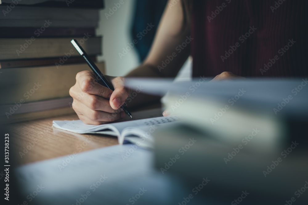 high school,college,university student writing in classroom or library ...