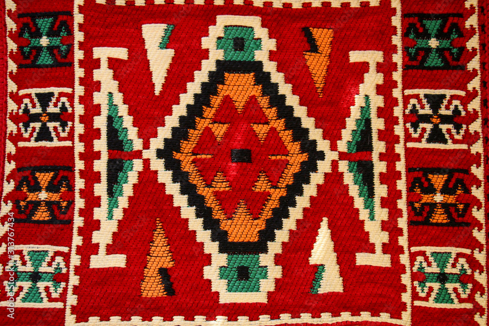 Old traditional carpet with a geometric pattern dark red and white ...