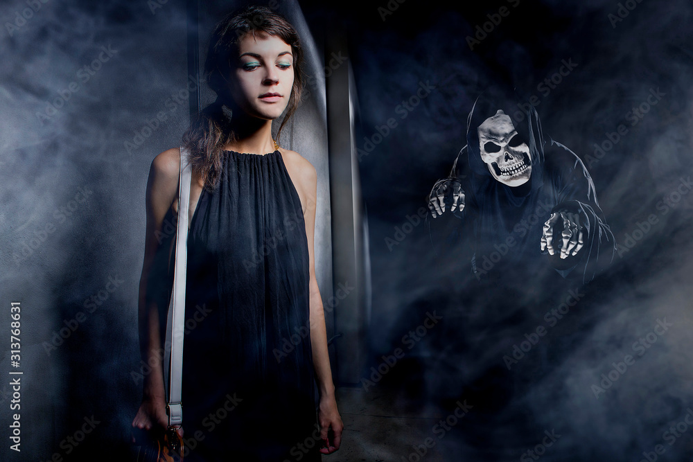 Woman in a dark alley with fog or mist imagining or seeing a demon or ...