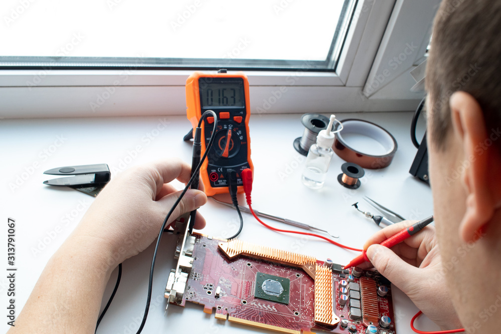 voltage measurement with a multimeter on a video card Stock Photo ...
