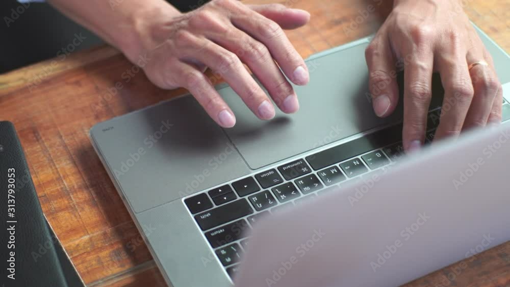 4k video of hands typing on laptop computer keyboard scrolling and ...