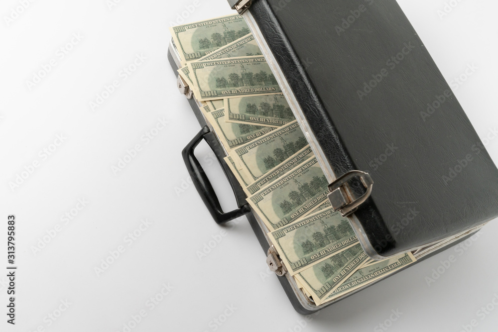 the opened vintage case full of cash dollar money, hundred banknote on ...