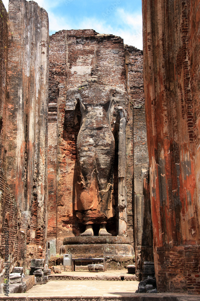 A giant masoned Standing Buddha statue without head in a temple in the ...
