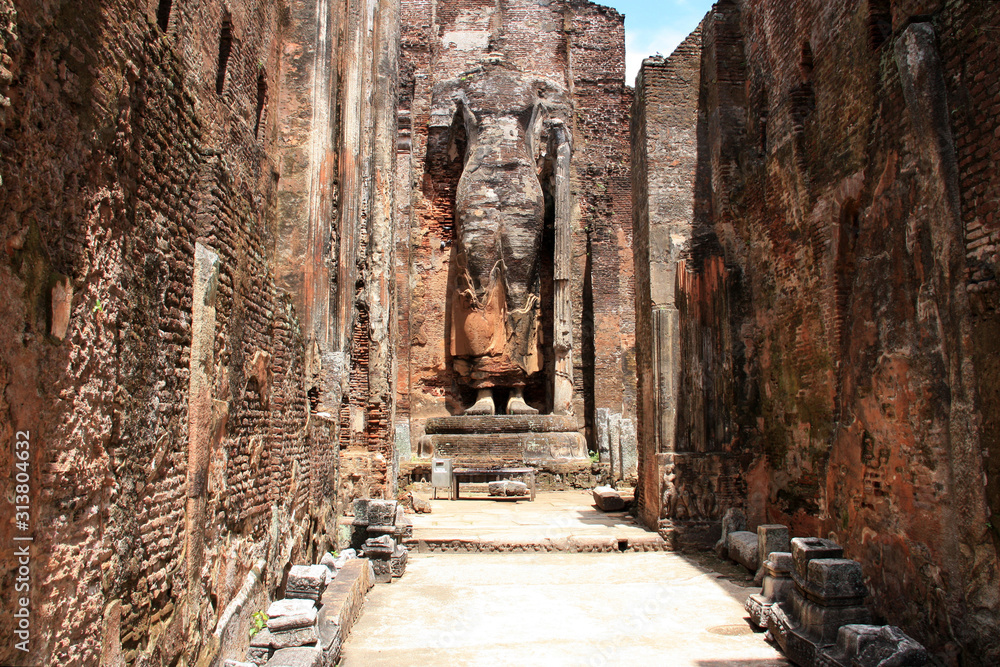 A giant masoned Standing Buddha statue without head in a temple in the ...