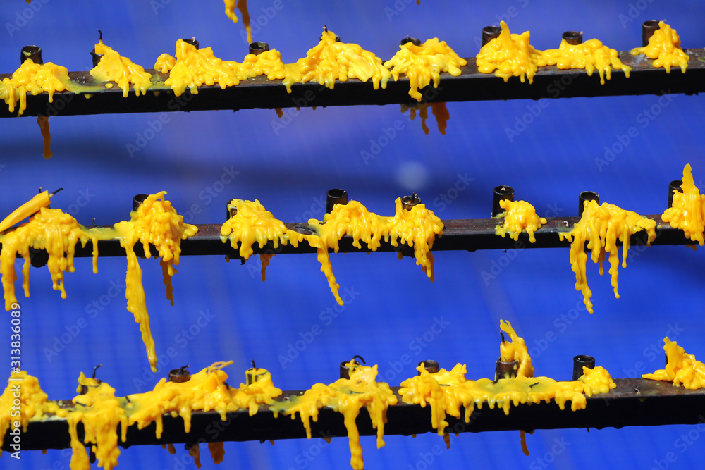 Melted and solidified wax candles at a buddhist temple, Thailand Stock ...