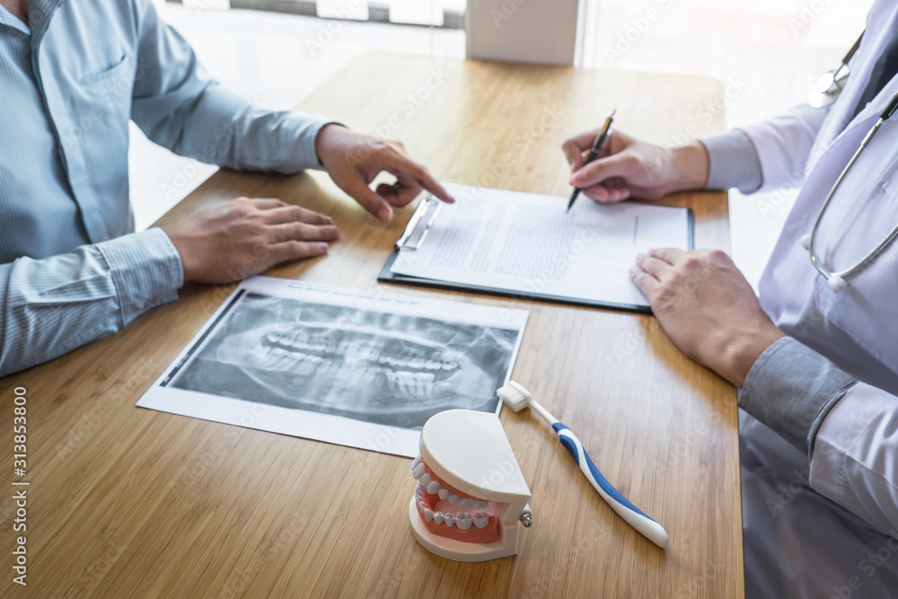 Professional Dentist showing jaw and teeth the x-ray photograph and ...